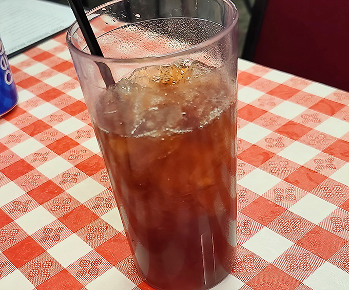 Sweet tea in a classic diner glass—the unofficial champagne of the Midwest. Amber liquid catching light like liquid sunshine.