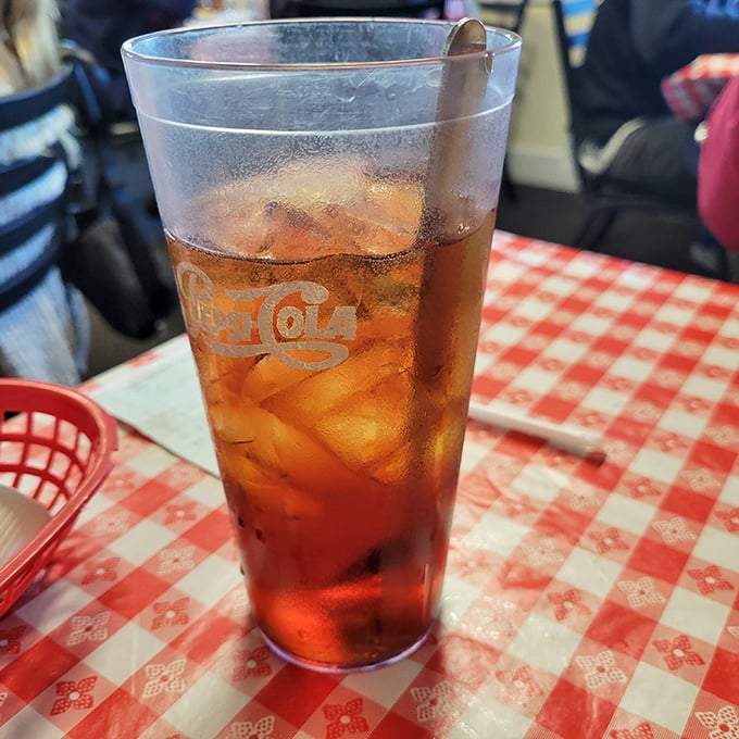 Sweet tea so perfectly balanced it should teach a masterclass—amber-colored liquid sunshine in a glass that never seems to empty.