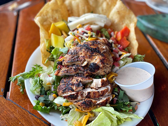 Blackened chicken perched atop a garden of greens and veggies—proof that seafood restaurants can still nail a land-based dish.