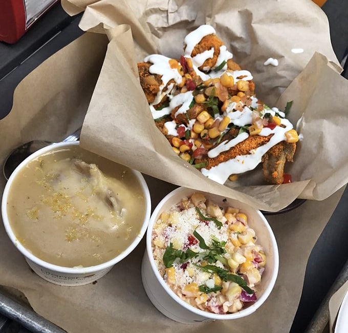 A feast for both eyes and stomach—crispy chicken, creamy sides, and what appears to be a corn salad creating the holy trinity of comfort food.