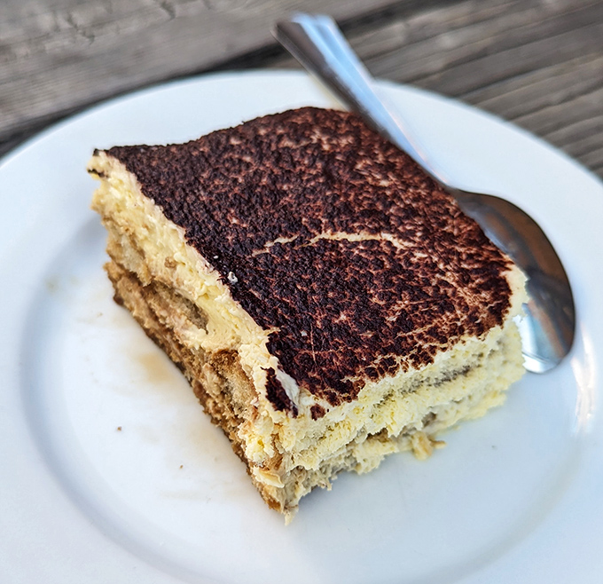 Tiramisu that looks like it's been studying abroad in Italy—layers of coffee-soaked perfection that make you want to skip the pizza entirely.