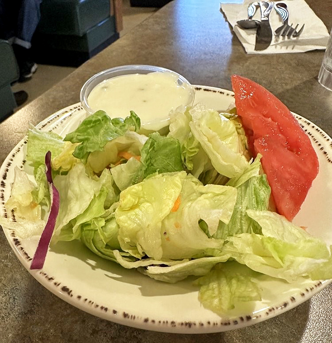 Even the humble side salad gets respect here. Fresh, crisp, and unpretentious—like the best conversations you'll have at the family dinner table.