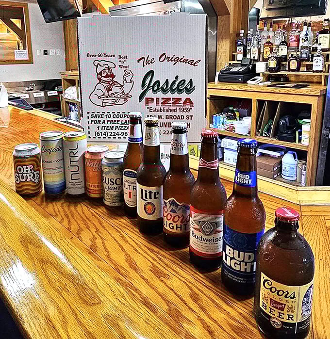 The lineup of cold ones standing at attention—like a liquid welcoming committee ready to wash down whatever pizza perfection you choose.