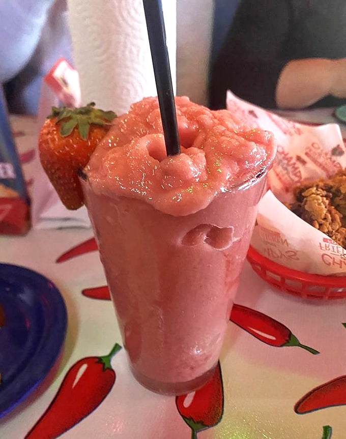 A strawberry daiquiri topped with fresh fruit—the kind of drink that makes you forget you're technically having dessert first.