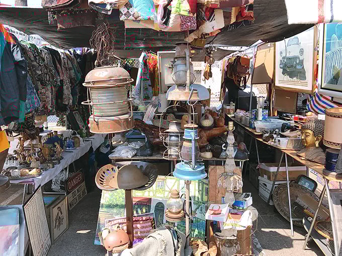 Organized chaos of nostalgia – where maritime lamps, Buddha statues, and forgotten treasures create a three-dimensional time capsule under canvas.