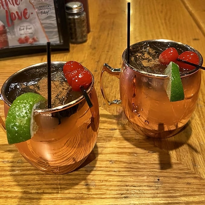 Moscow Mules with a Wisconsin twist—copper mugs gleaming with promise, garnished with cherries that whisper, "This isn't your standard cocktail."