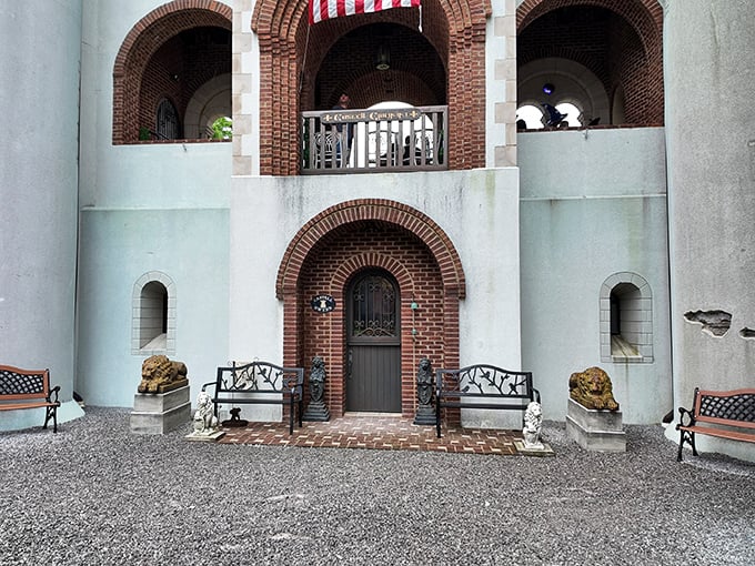 A royal welcome awaits at this ornate entryway. Stone benches flank the door while decorative lions stand guard, offering both hospitality and a hint of medieval majesty.
