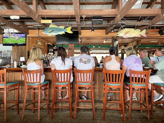 The bar area – where solo travelers become temporary locals and everyone's united by their appreciation for cold drinks and fresh catches.