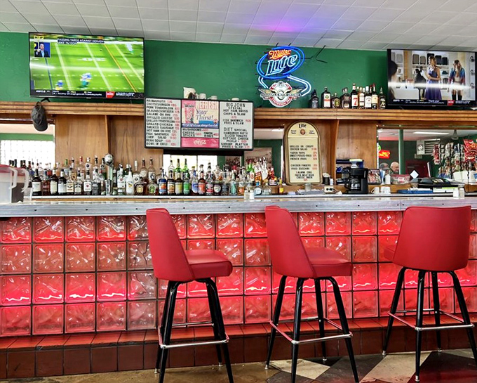 The bar area glows with neon signs and red glass blocks—a time capsule where cold drinks and warm conversation have flowed for generations.