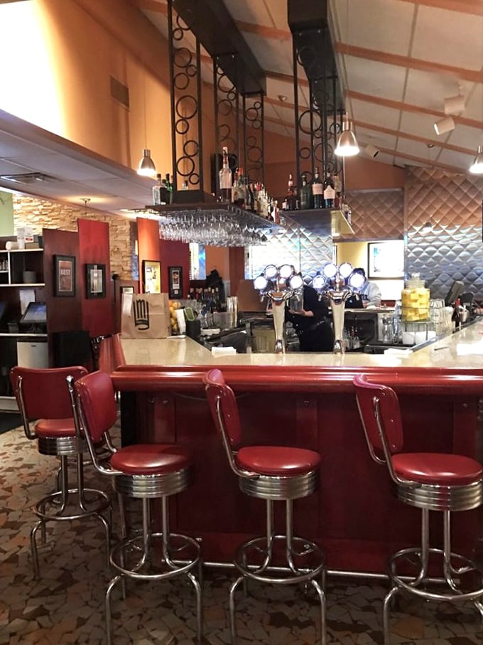 The bar area—where classic cocktails meet modern mixology under the watchful gaze of vintage-inspired decor. Cheers to that!