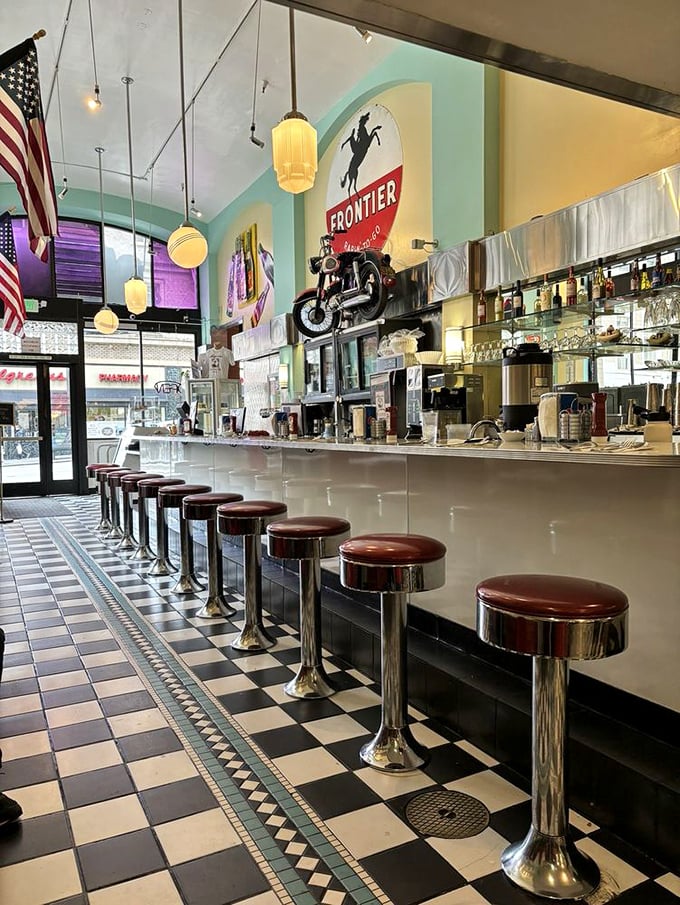 The counter at Lori's—where strangers become temporary neighbors, united by chrome, vinyl, and the universal language of comfort food.