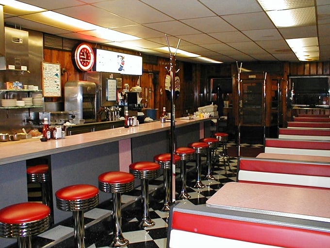 The counter—where solo diners find community, newspapers find purpose, and those classic red stools have cradled generations of Altoona appetites.