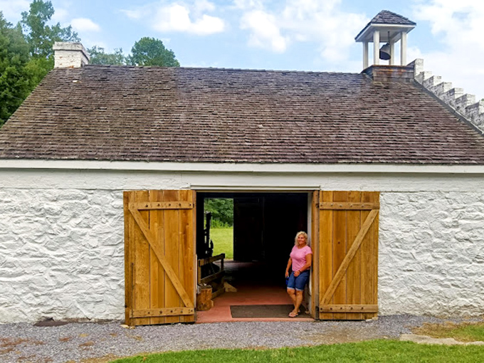 This historic white barn doesn't just store history—it displays it with barn doors flung wide open, inviting you into Pennsylvania's agricultural past.