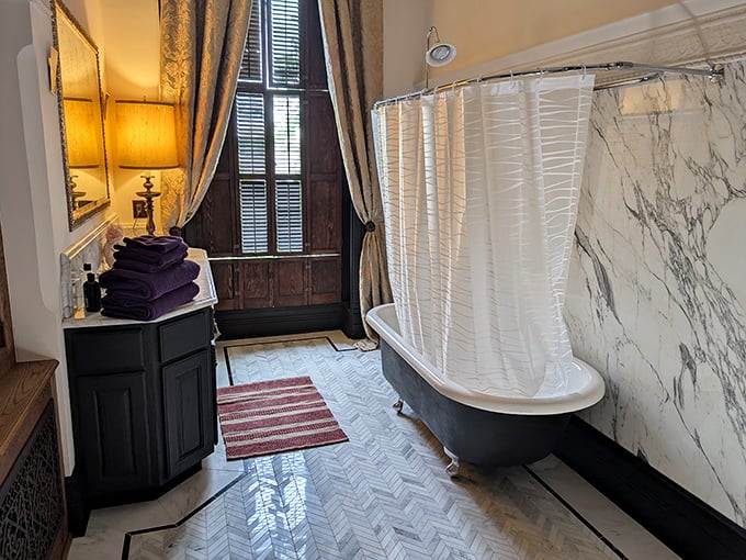 Even the bathroom exudes Victorian elegance with its clawfoot tub and marble walls – the kind of place where you'd spend an hour soaking with a good mystery novel.