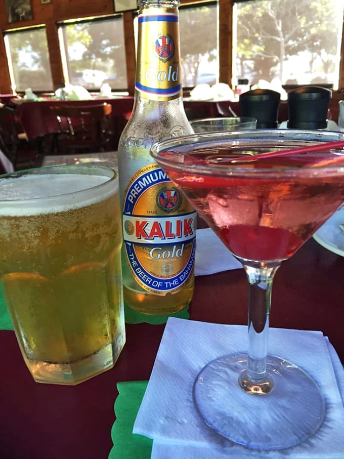 Island vibes in liquid form: a cold Kalik beer and a perfectly mixed cocktail—because boat rides and good food deserve proper liquid accompaniments.