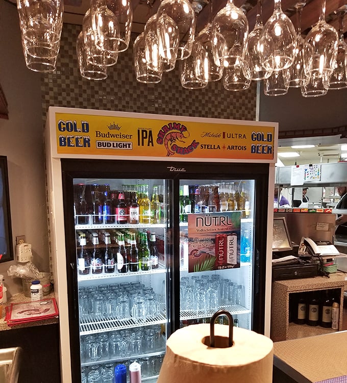 The beer fridge—Florida's version of a treasure chest. Cold beverages await behind glass doors, ready to tame the fire of spicy seafood.