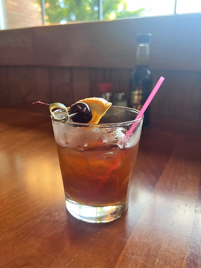 The kind of classic cocktail that Don Draper would order while plotting his next big ad campaign – amber liquid, cherry garnish, and decades of Portland history.