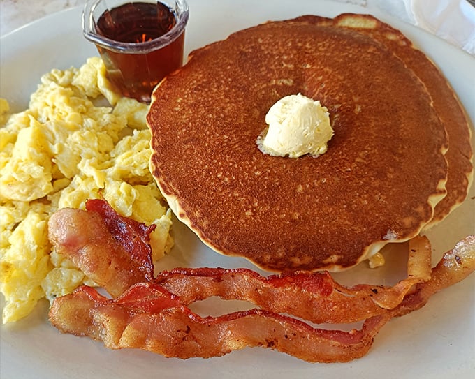 Breakfast perfection isn't complicated—just a pancake the size of your face, eggs that respect their mission, and bacon that means business.