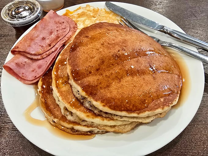 Pancakes stacked higher than your weekend expectations, glistening with syrup and flanked by ham—breakfast as your grandparents intended it.