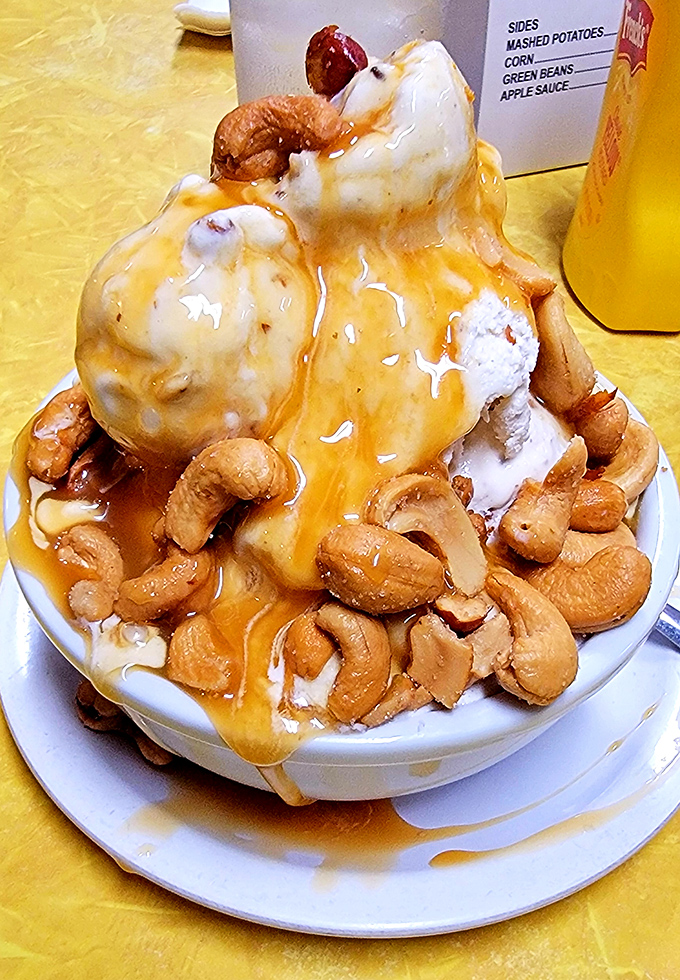 Butterscotch cascading over vanilla ice cream like liquid gold, with cashews standing guard. This isn't dessert—it's therapy in a bowl.