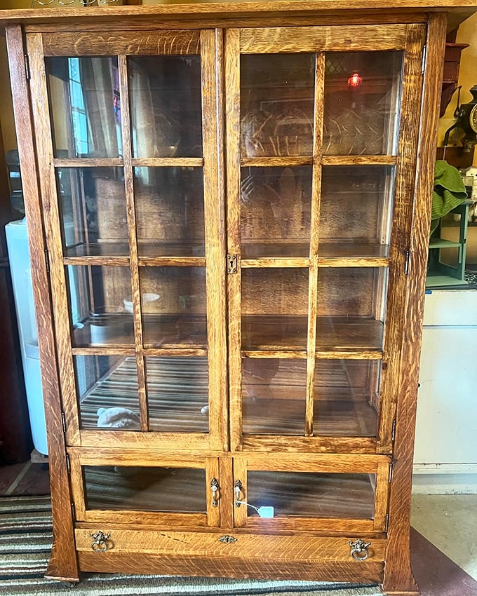 An oak display cabinet with the kind of craftsmanship that makes modern furniture weep. They literally don't make them like this anymore—and your IKEA knows it.