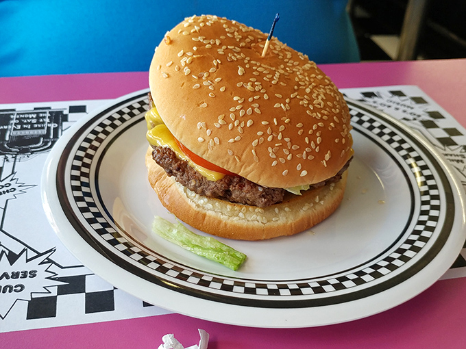 A proper diner cheeseburger doesn't need truffle aioli or a brioche bun—just honest beef, melty American cheese, and a pickle spear standing guard.