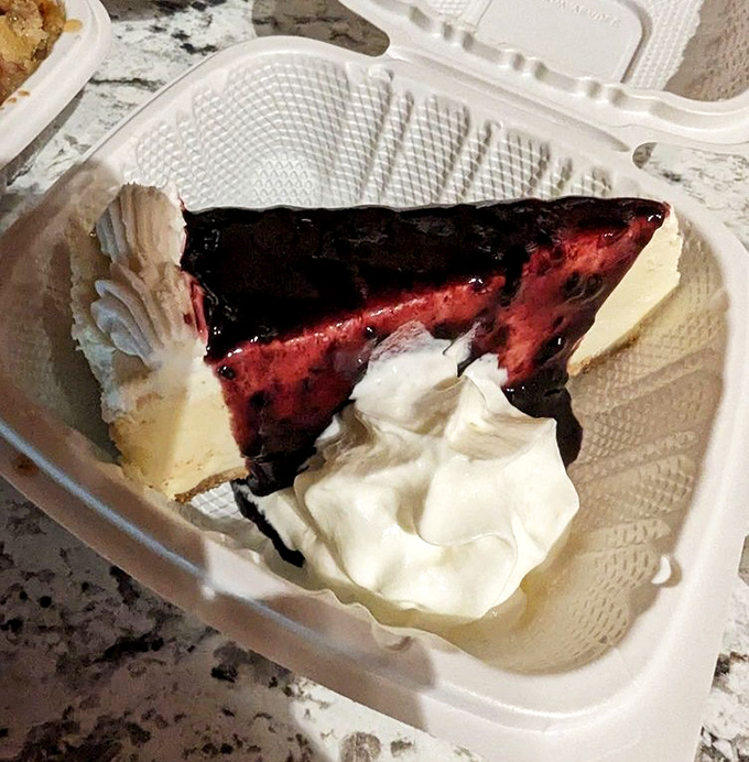 Cheesecake that's having an identity crisis—is it dessert or artwork? The berry topping adds just enough tang to cut through the richness.