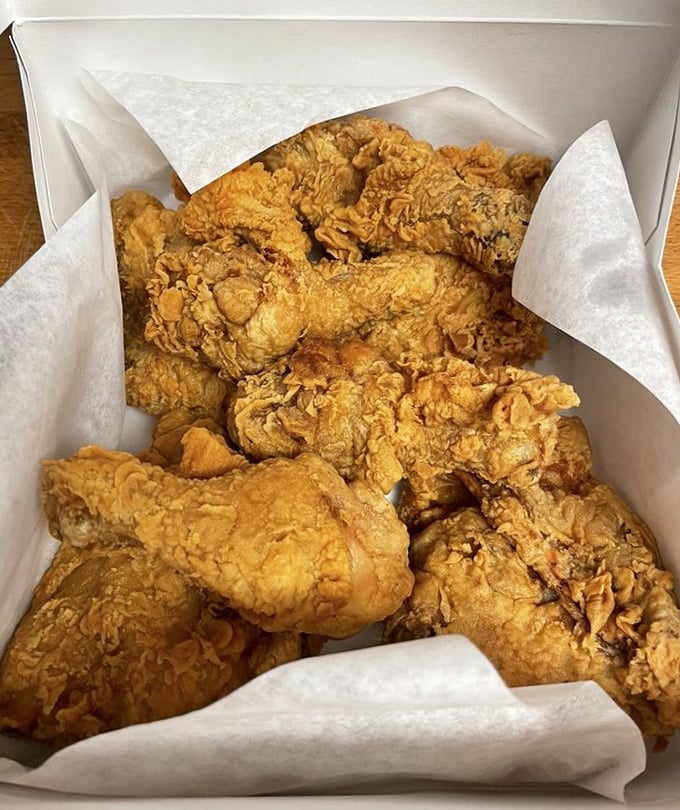Fried chicken that makes Colonel Sanders nervous. Golden, craggly crust protecting juicy meat beneath—the kind worth driving across town for.