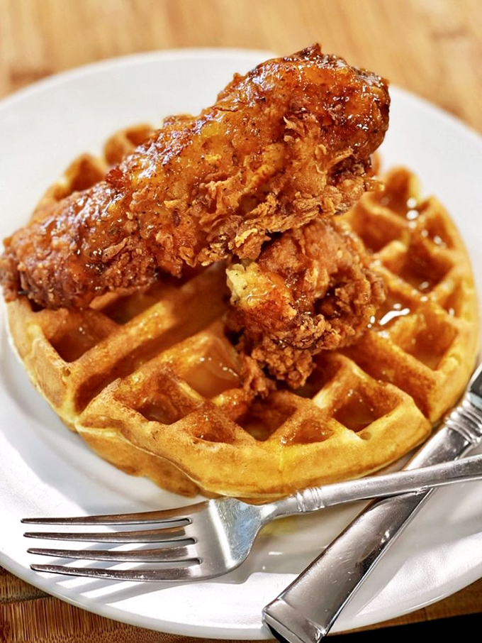 Southern comfort meets breakfast rebellion. Golden waffle foundation, crispy chicken superstructure—architecture you can eat without building permits.