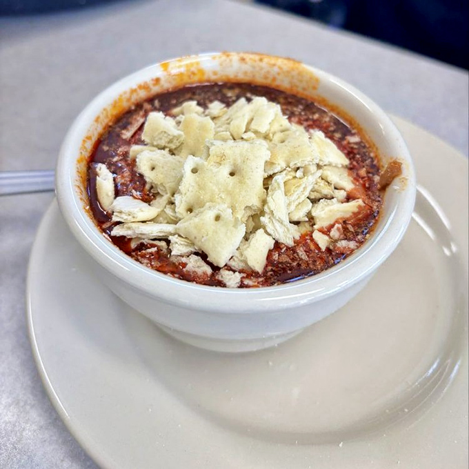 Chili topped with saltine crackers—comfort food mathematics at its finest. The bowl might be white, but the memories it creates are technicolor.