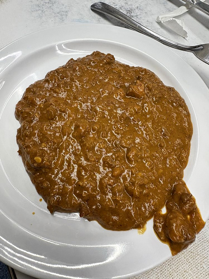 The legendary chili—beanless, meaty, and perfectly spiced. This isn't just a topping; it's the cornerstone of Detroit's coney culture. 
