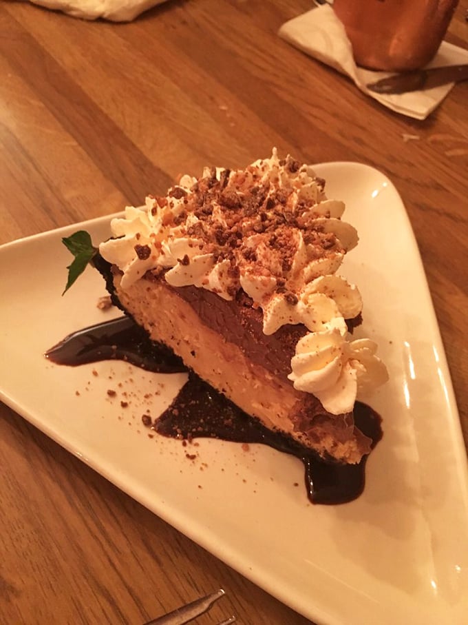 This chocolate peanut butter pie doesn't just end your meal—it throws a celebration. The whipped cream isn't decoration; it's the pie's victory dance.