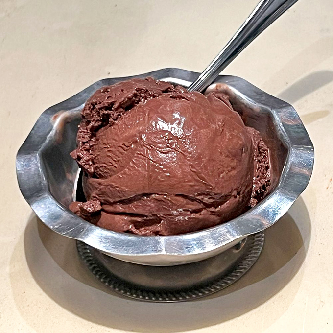 Chocolate so intense it should come with a warning label. This isn't just dessert—it's therapy in a silver dish.