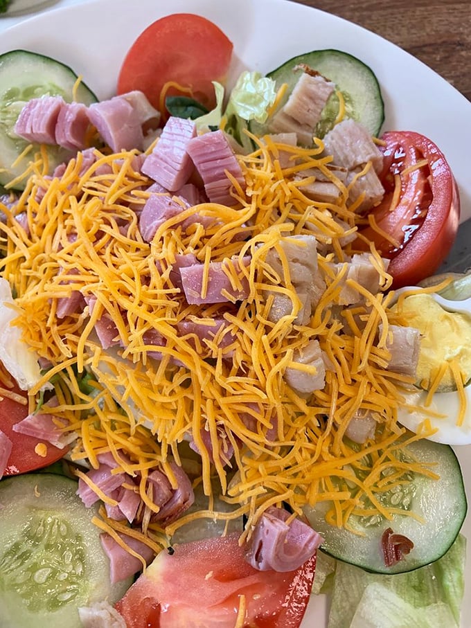 A chef's salad that actually satisfies – proof that vegetables can party too when invited to mingle with generous portions of ham, turkey and cheese.