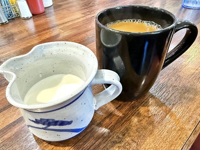Coffee served in sturdy mugs with real cream—none of that fancy foam art needed when the brew is this good.