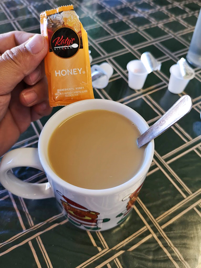 Coffee served with honey packets—because sometimes the simple pleasures are the most profound. The mug says it all.