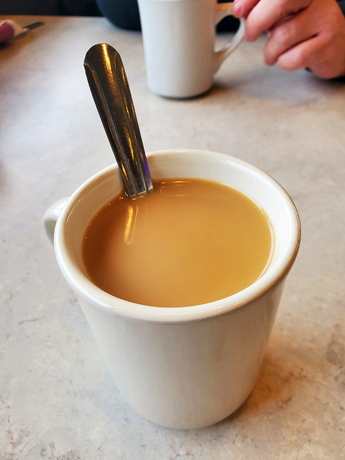 The humble diner coffee cup—civilization's most perfect vessel. Contains liquid motivation that keeps coming until you surrender or float away.