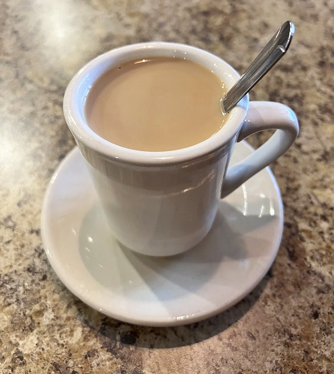 Coffee in a proper diner mug – the original social network where ideas, gossip, and caffeine flow with equal enthusiasm.