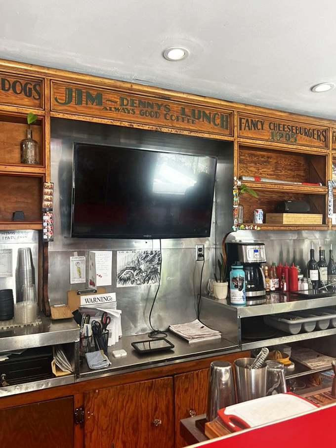 Behind the counter where burger dreams come true. That vintage wooden signage has witnessed decades of "mmms" and "wows" from satisfied customers.