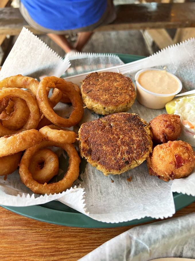Crab cakes and onion rings: the dynamic duo of seafood dining. Crispy exteriors giving way to tender interiors—it's textural poetry on a plate.