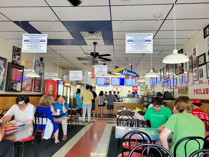 The lunch rush – a symphony of satisfied munching and Eagles talk. These tables have heard decades of Philly sports debates.