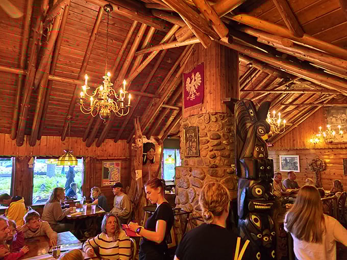 The rustic wooden interior doesn't just house diners—it envelops them in a century-old story told through carved beams and antler chandeliers.