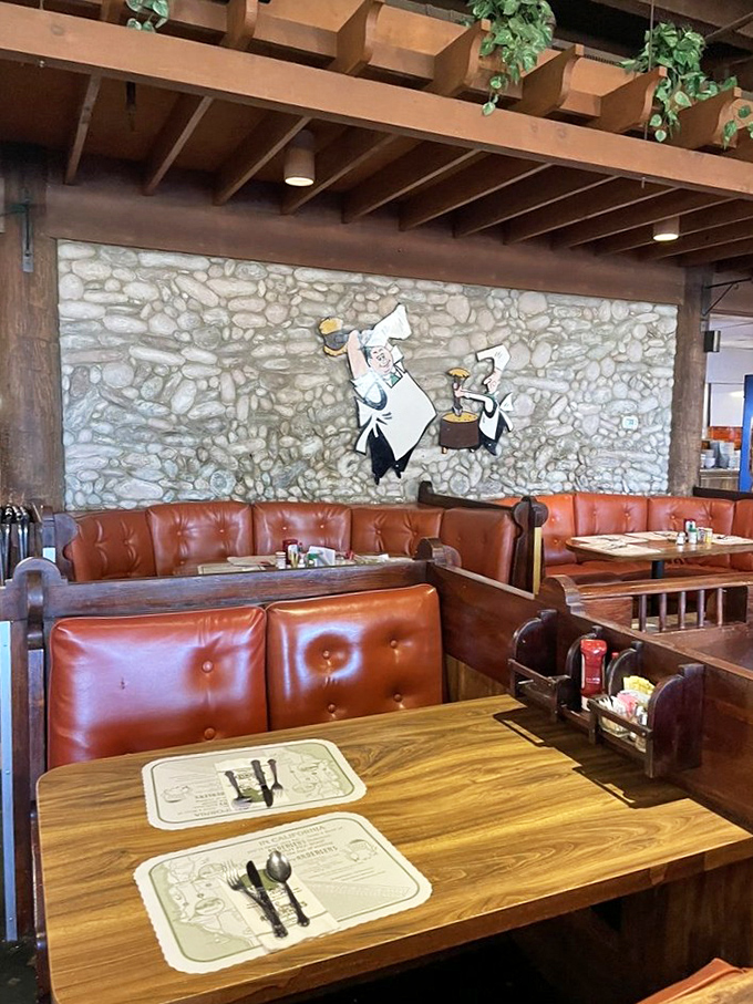 The dining area's stone wall backdrop and those iconic cartoon characters create the perfect setting for your mid-road-trip feast. Comfort food deserves comfortable seating.