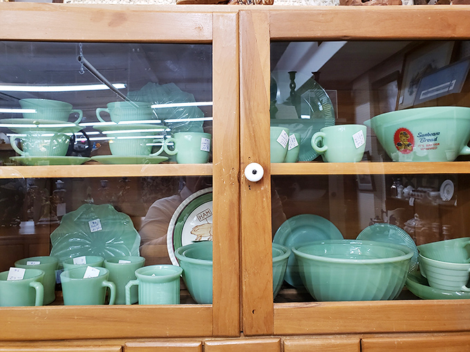 Jadeite dishware gleaming behind glass—proof that our grandparents understood the Instagram-worthy aesthetic long before filters were invented.