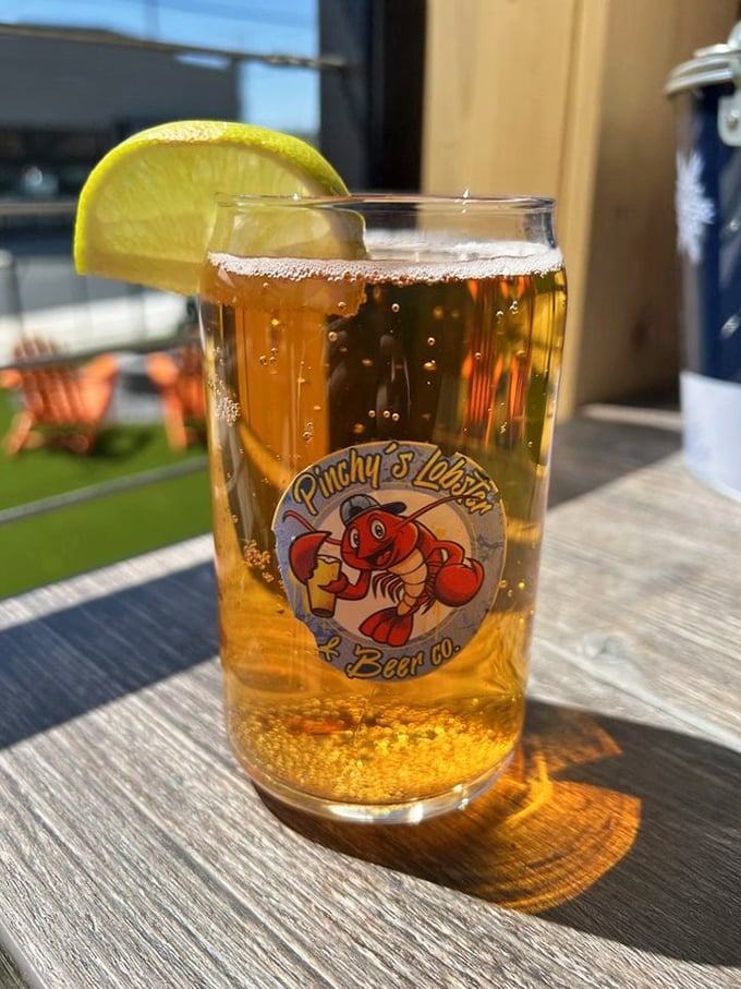 A cold beer with a slice of citrus, served in Pinchy's branded glass—because sometimes the perfect accompaniment to seafood is simplicity itself, cold and refreshing.