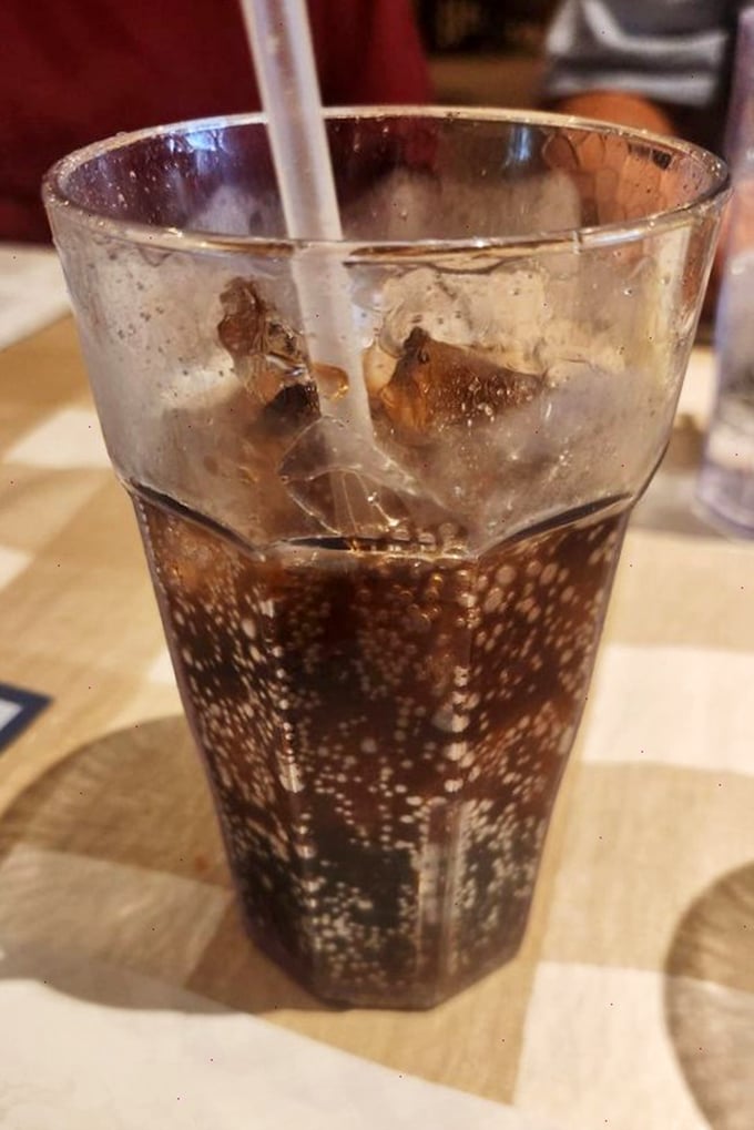 Even the beverages get special treatment here—a classic soda with enough ice to survive the apocalypse, served in those distinctive textured glasses from grandma's cabinet.