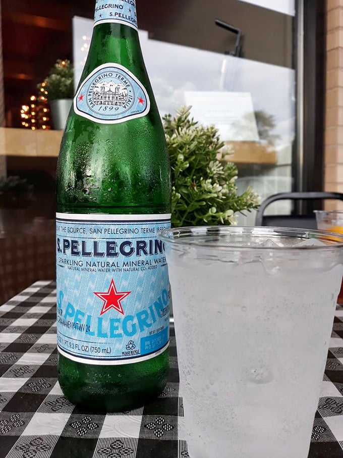 Nothing says "authentic Italian experience" quite like San Pellegrino on a checkered tablecloth—a simple pleasure that somehow elevates everything around it.