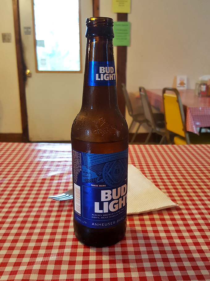 A cold Bud Light on a checkered tablecloth—sometimes the simplest pleasures are the perfect accompaniment to comfort food masterpieces.