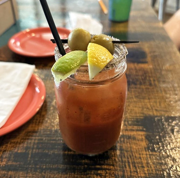 This isn't just a Bloody Mary—it's a garden in a glass with enough garnishes to count as a small meal. Sunday brunch's best friend.
