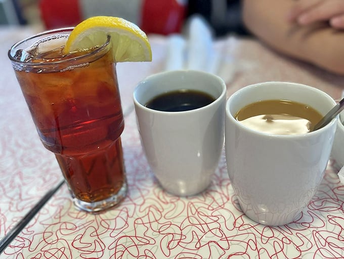 The triumvirate of diner beverages: sweet tea with lemon, strong black coffee, and cream—a liquid foundation for any proper meal.